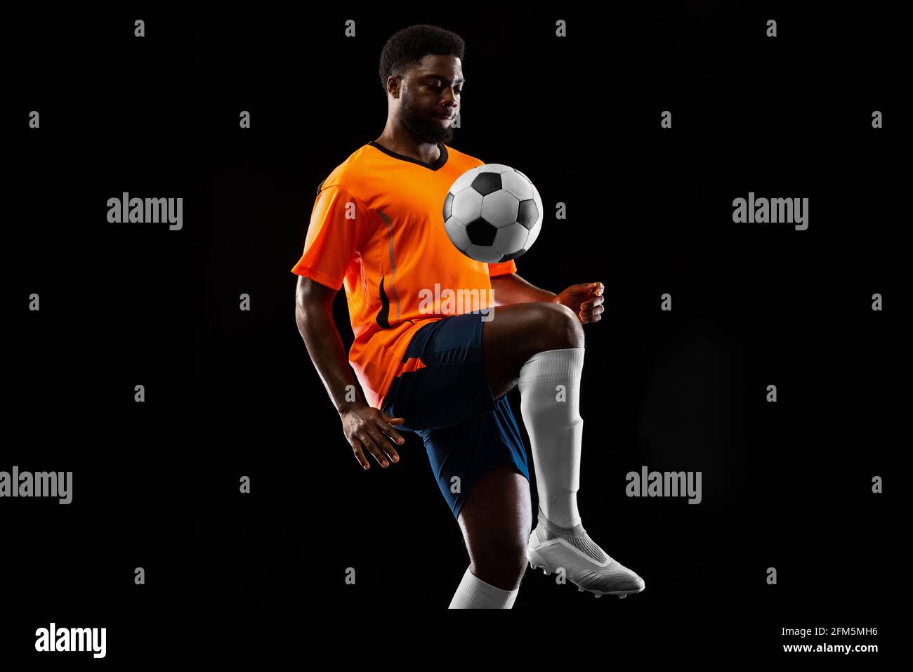 African-american football player playing isolated on black background ...