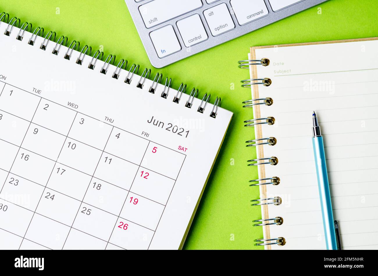June 2021 calendar with note book on green color background Stock Photo ...