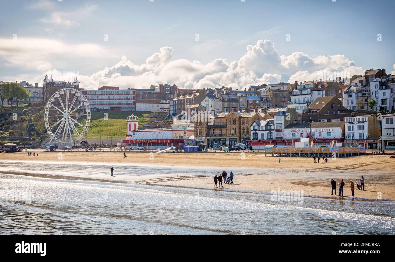 People enjoy the beach at Scarborough in a Spring sunshine. Town ...