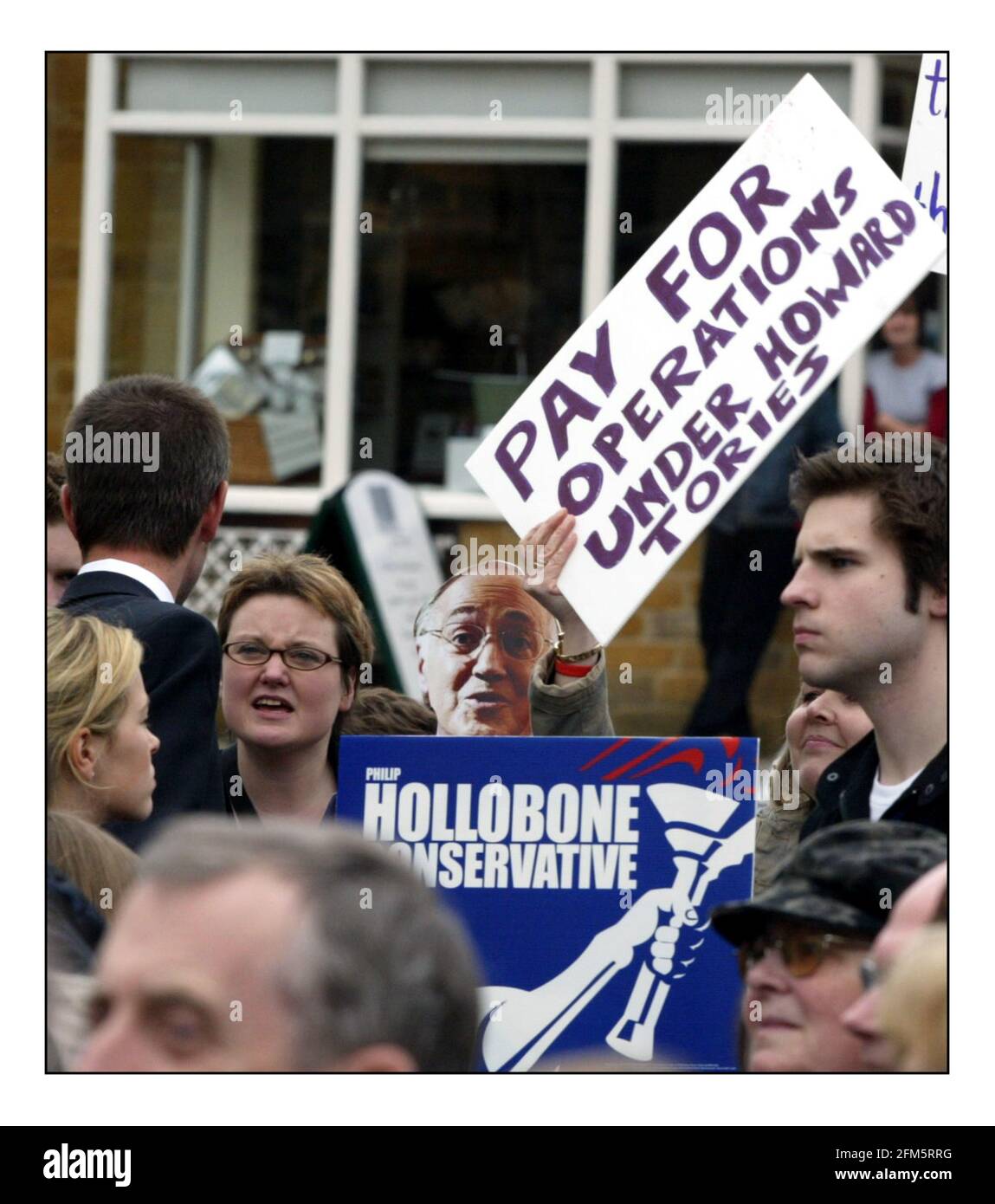 A poster of Michael Howard seen through a crowd on his visits to ...