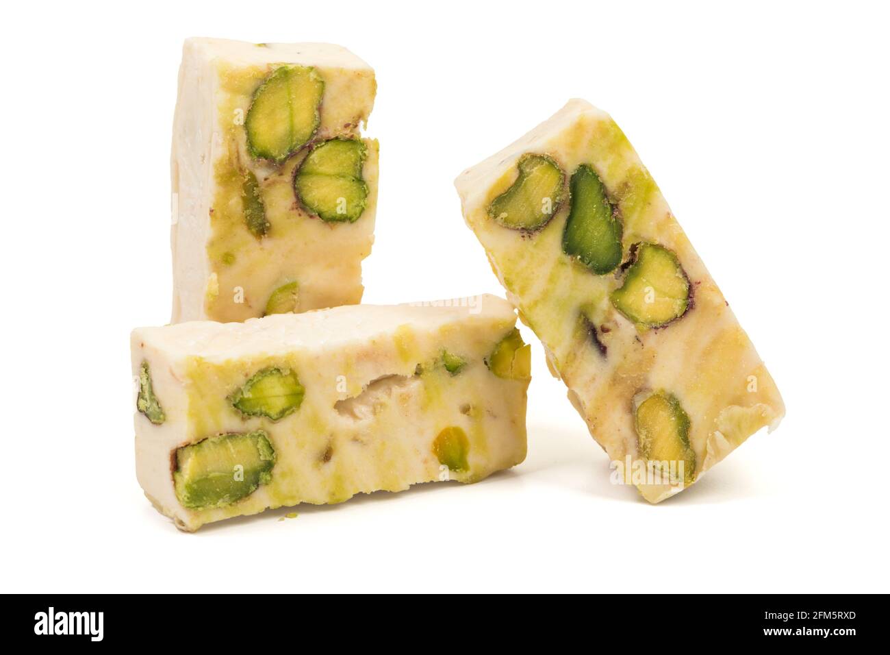 Italian Torrone nougat candy blocks with pistachios isolated on white ...