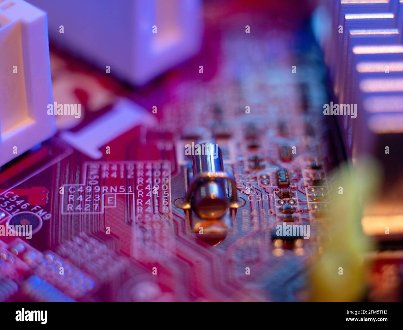 Computer motherboard, microchips close-up in color illumination ...