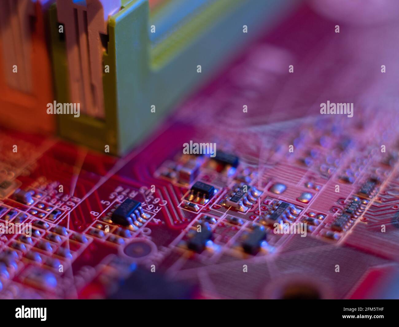 Computer motherboard, microchips close-up in color illumination ...