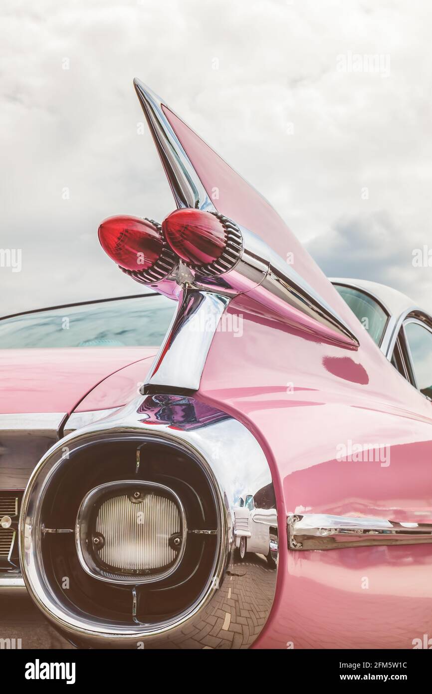 Retro styled image of the rear end of a pink classic car Stock Photo ...
