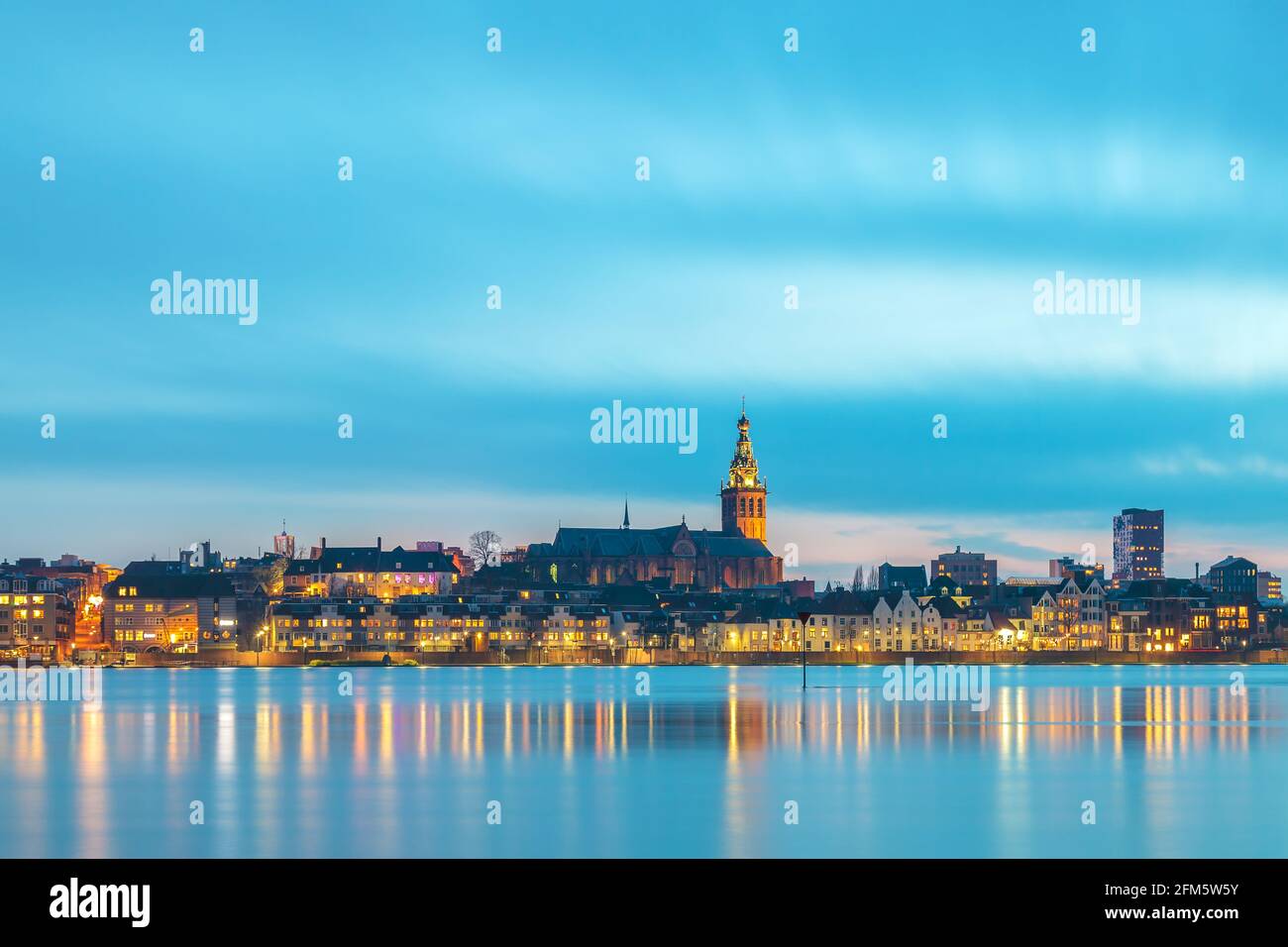 Evening view of the Dutch city of Nijmegen with the flooded river Waal ...