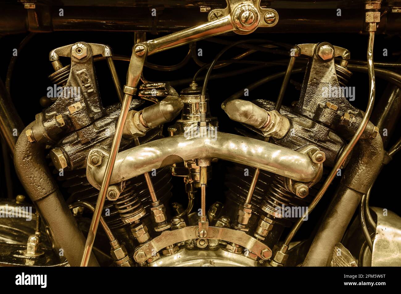 Sepia toned close-up view of a vintage motorcycle engine from the early ...