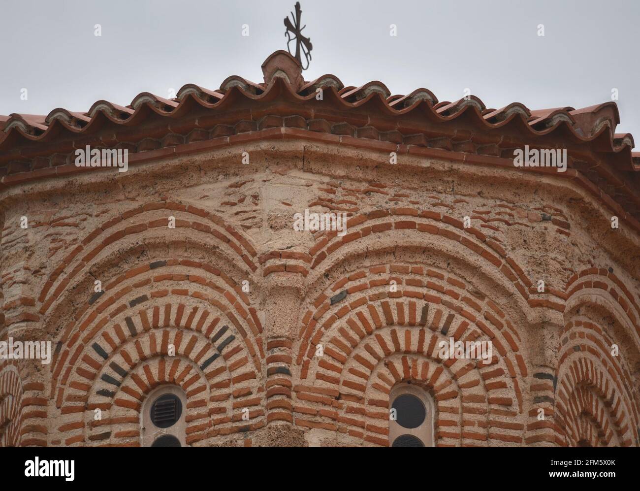 Handcrafted red clay tile and stone Byzantine church exterior wall of ...