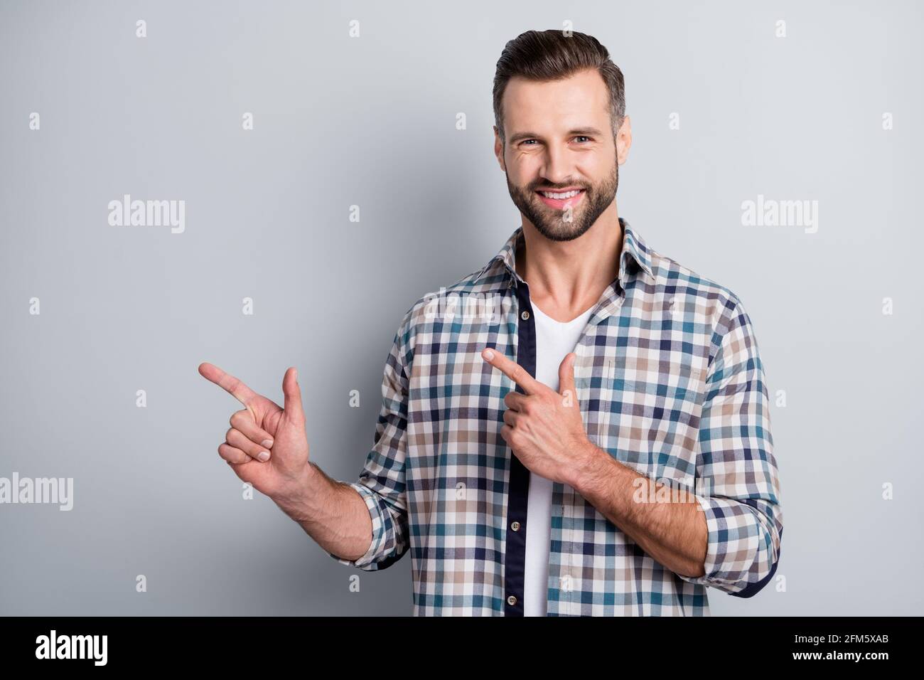 Photo of young handsome cheerful positive smiling man point finger ...