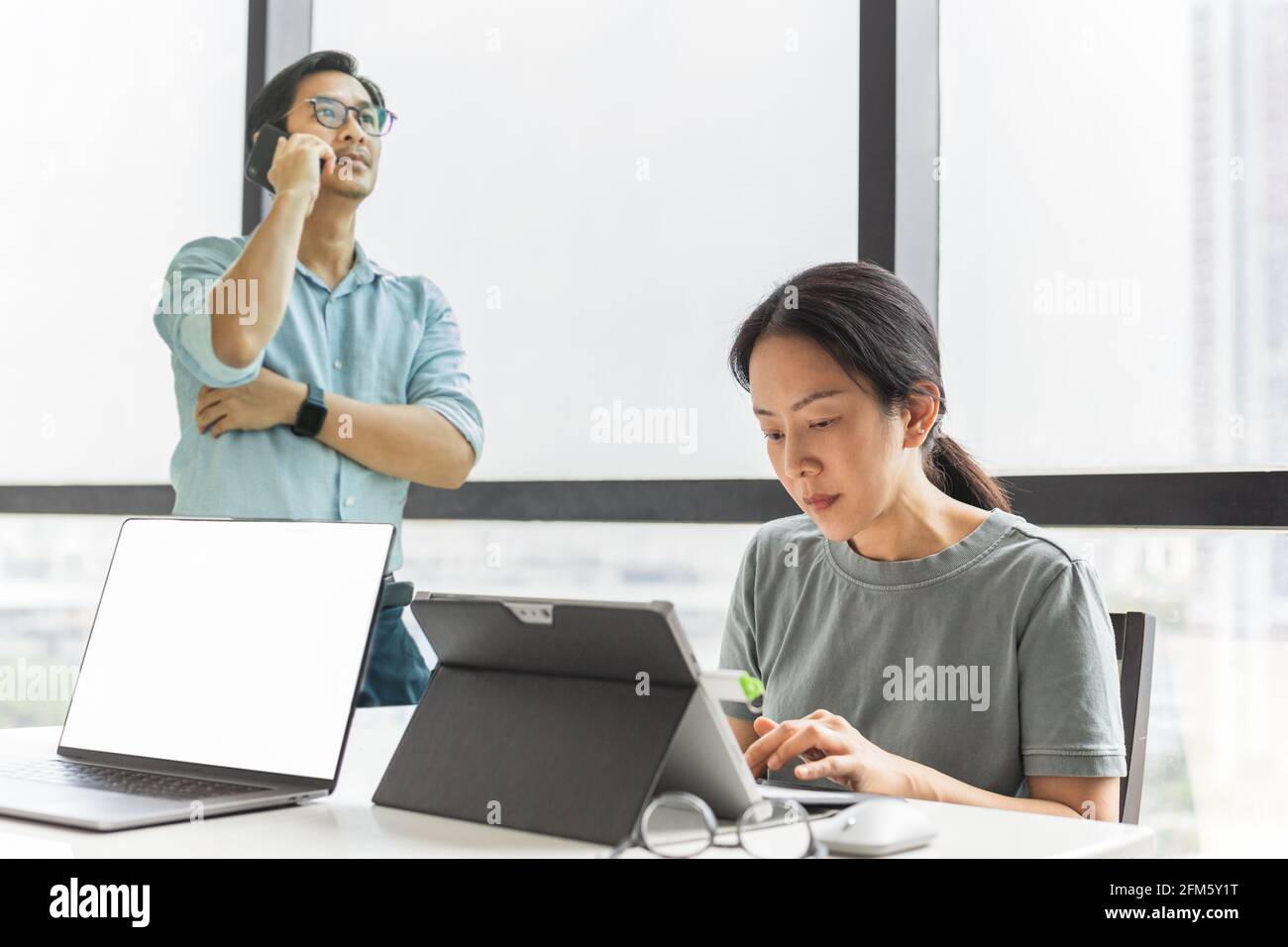 Business teamwork working on laptop at office building Stock Photo - Alamy