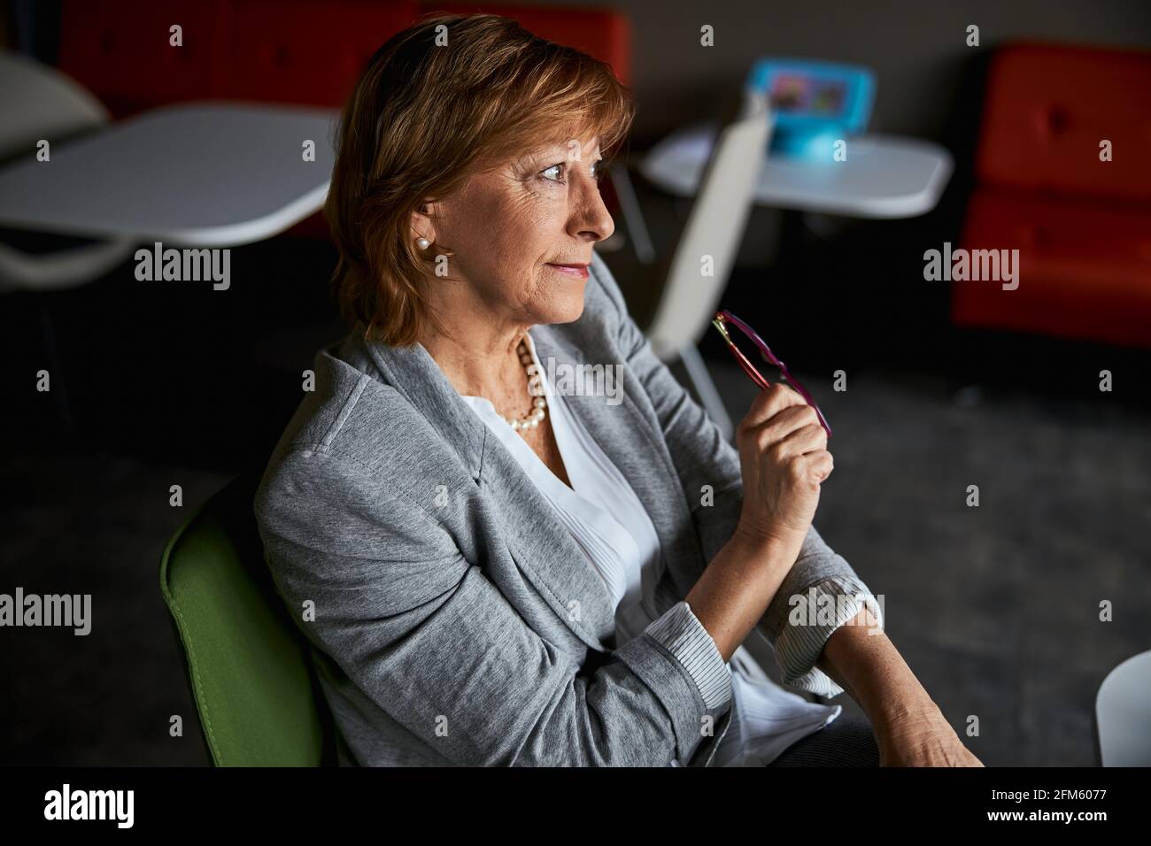 Delighted female person sitting in semi position Stock Photo - Alamy