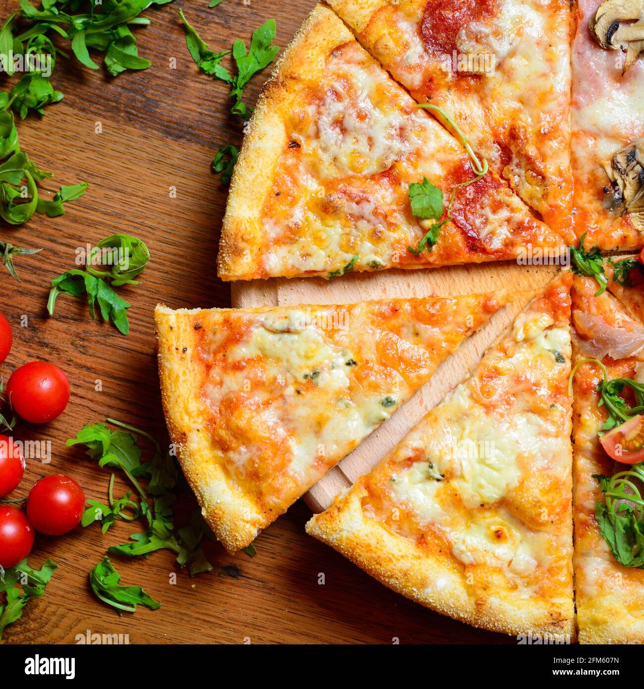 Top down view of italian pizza with cheese, cherry tomatoes, mushrooms ...