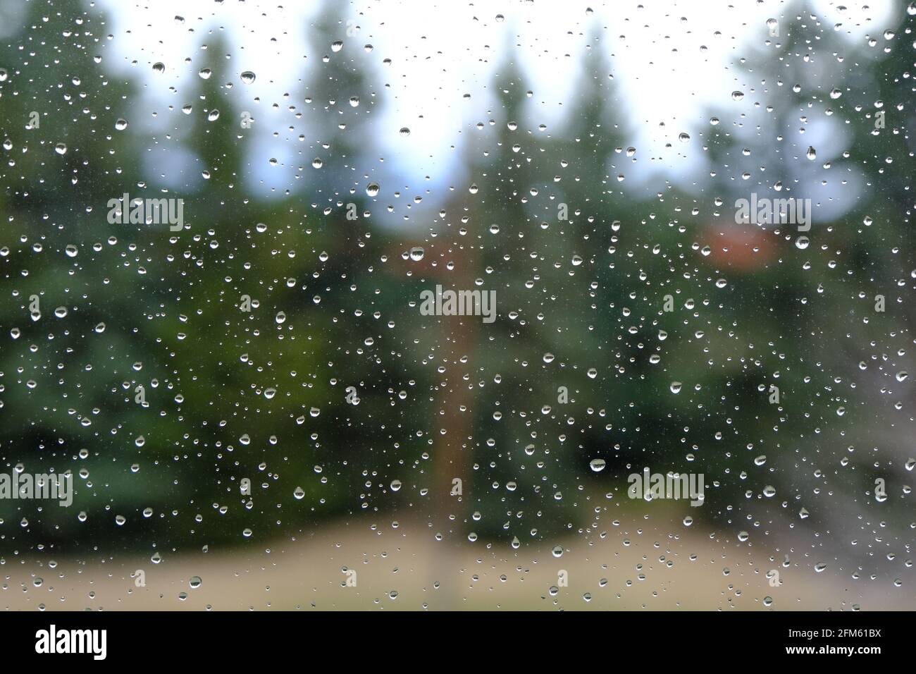 Raindrops falling and running down office windows Stock Photo - Alamy