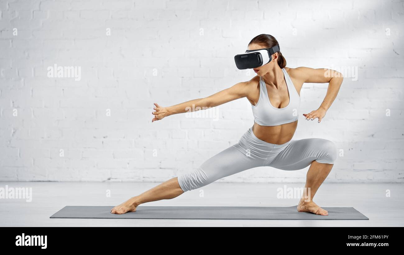 Barefoot woman in vr headset standing on yoga mat Stock Photo - Alamy