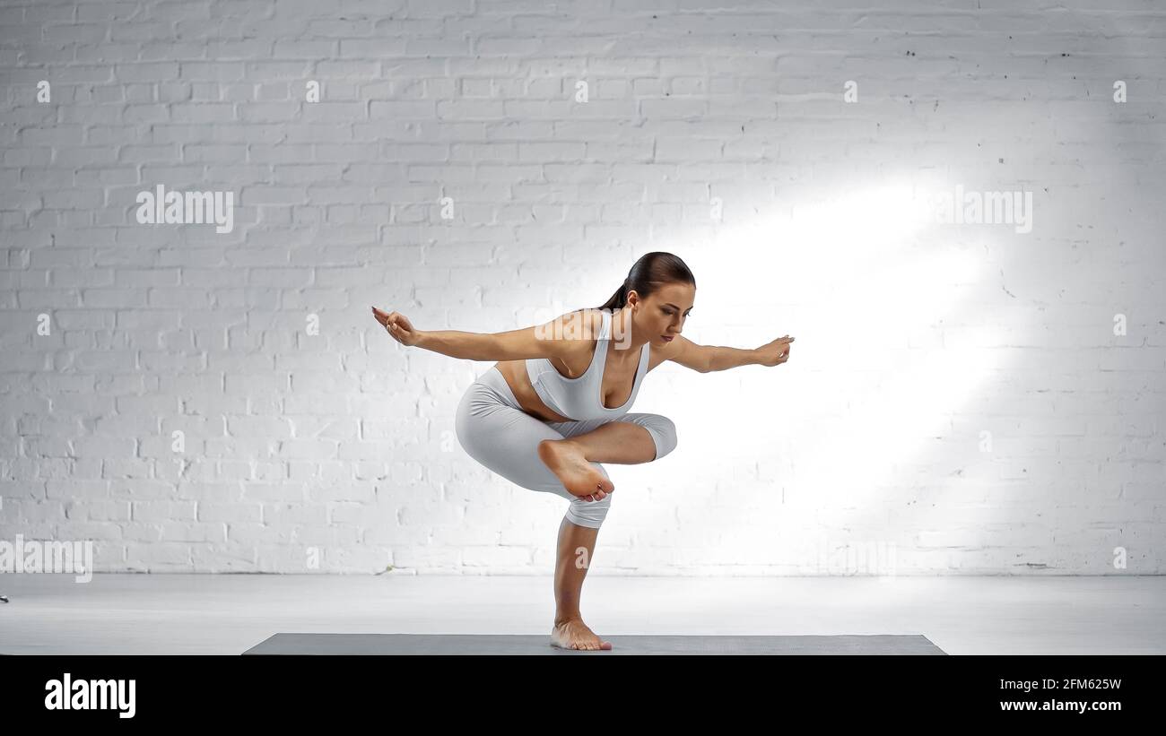 Woman balancing on one leg hi-res stock photography and images - Alamy