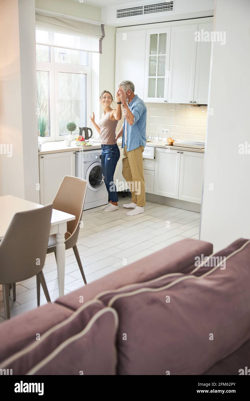 Happy people having fun together in kitchen Stock Photo - Alamy