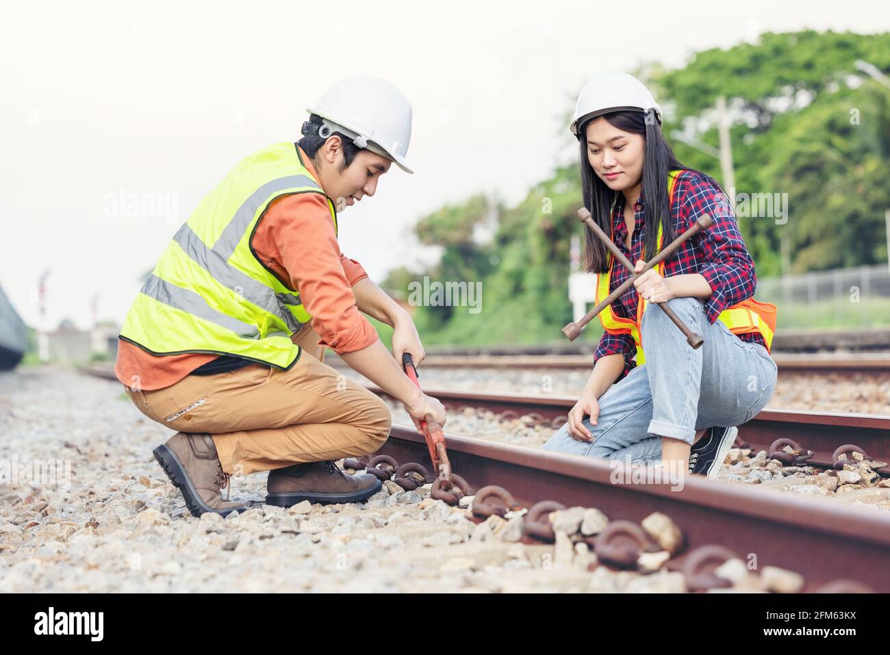 Team engineer holding wrench for repair working on train site, safety ...