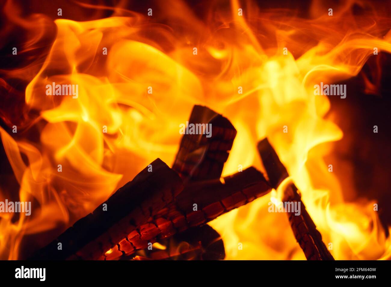 A fire burns in a fireplace, Fire to keep warm. Logs burning in a ...