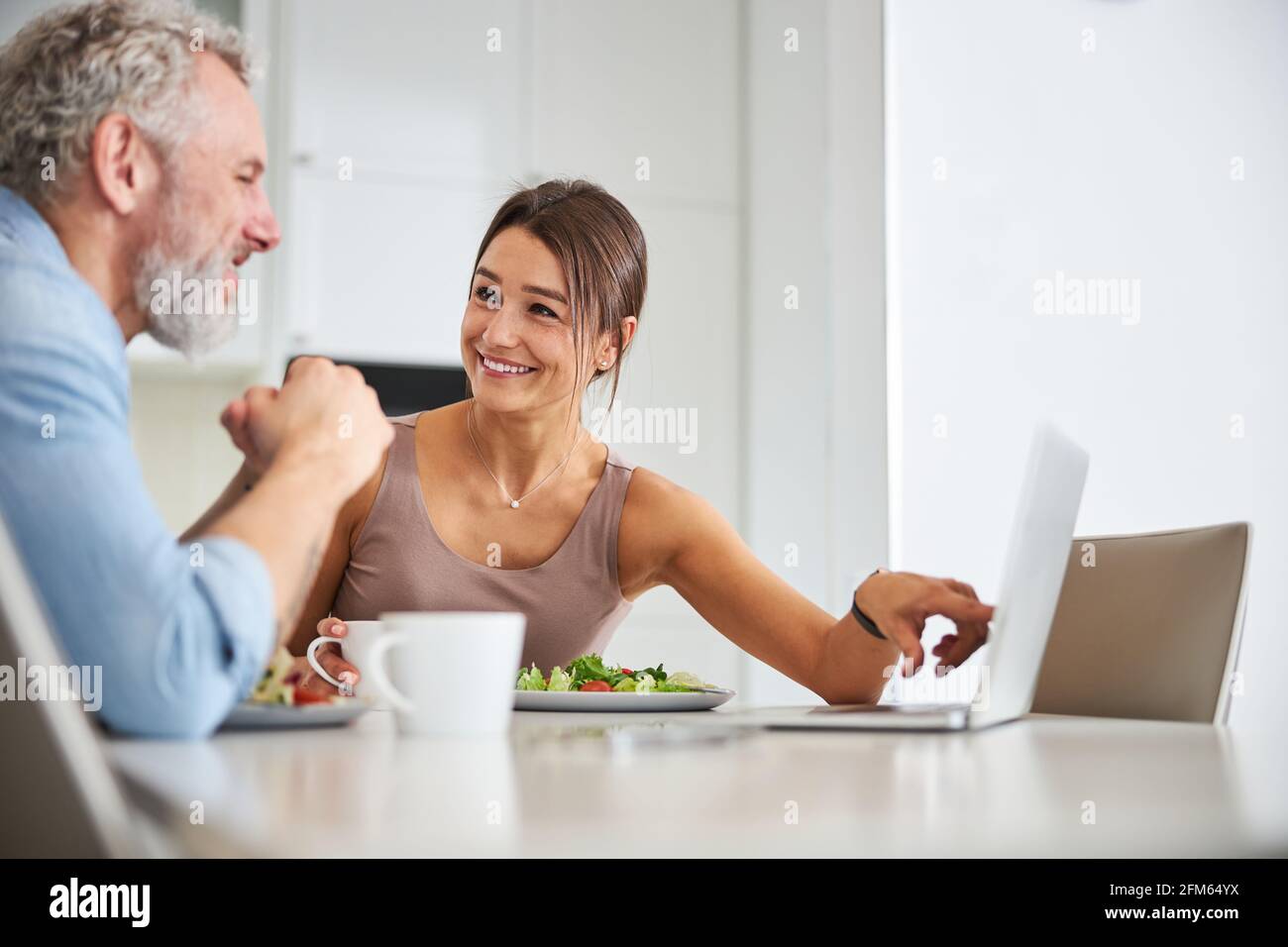 Cute young woman pointing at screen of computer Stock Photo - Alamy