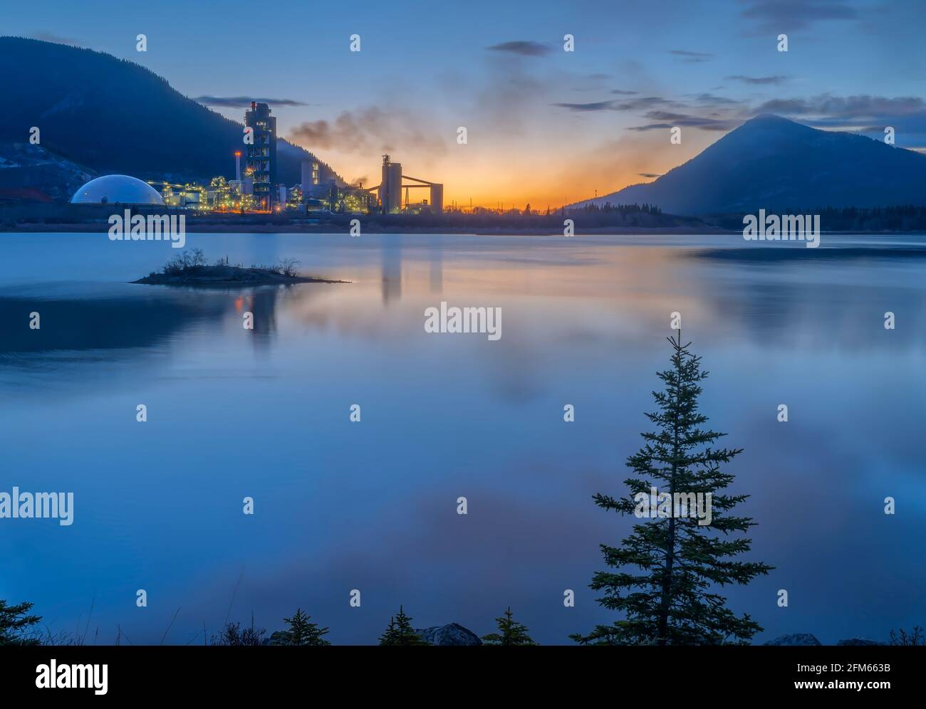 Sunrise at Lac des Arcs and the Exshaw cement plant in Alberta, Canada ...