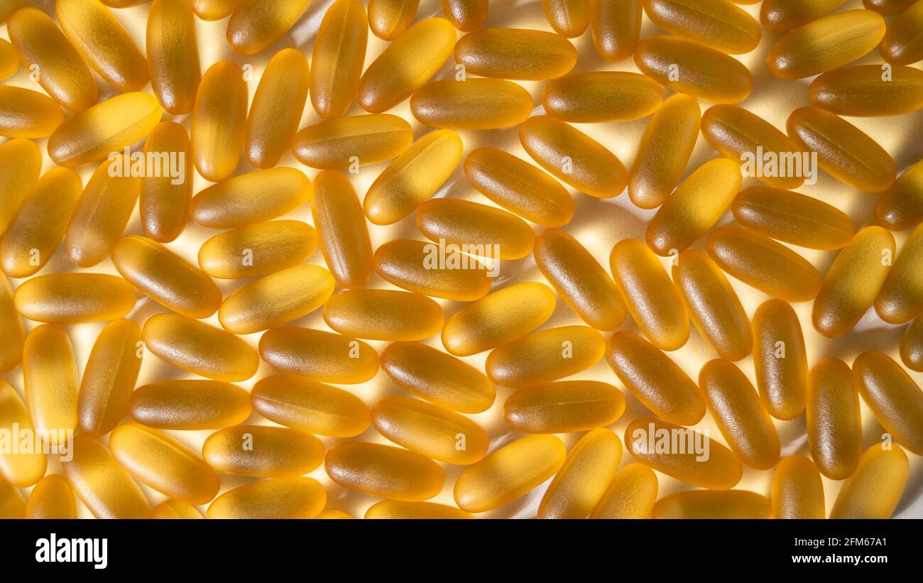 Close-up of golden omega three capsules. Dietary supplement fish oil ...