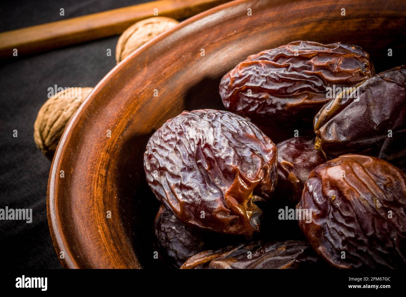 Big luxury dried date fruit in bowls on the dark surface, kurma ramadan ...