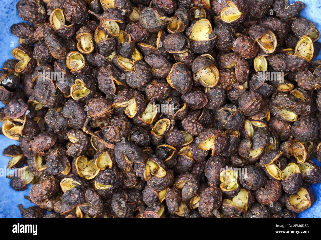 Macro full frame closeup of raw brown whole chinese sichuan timut ...