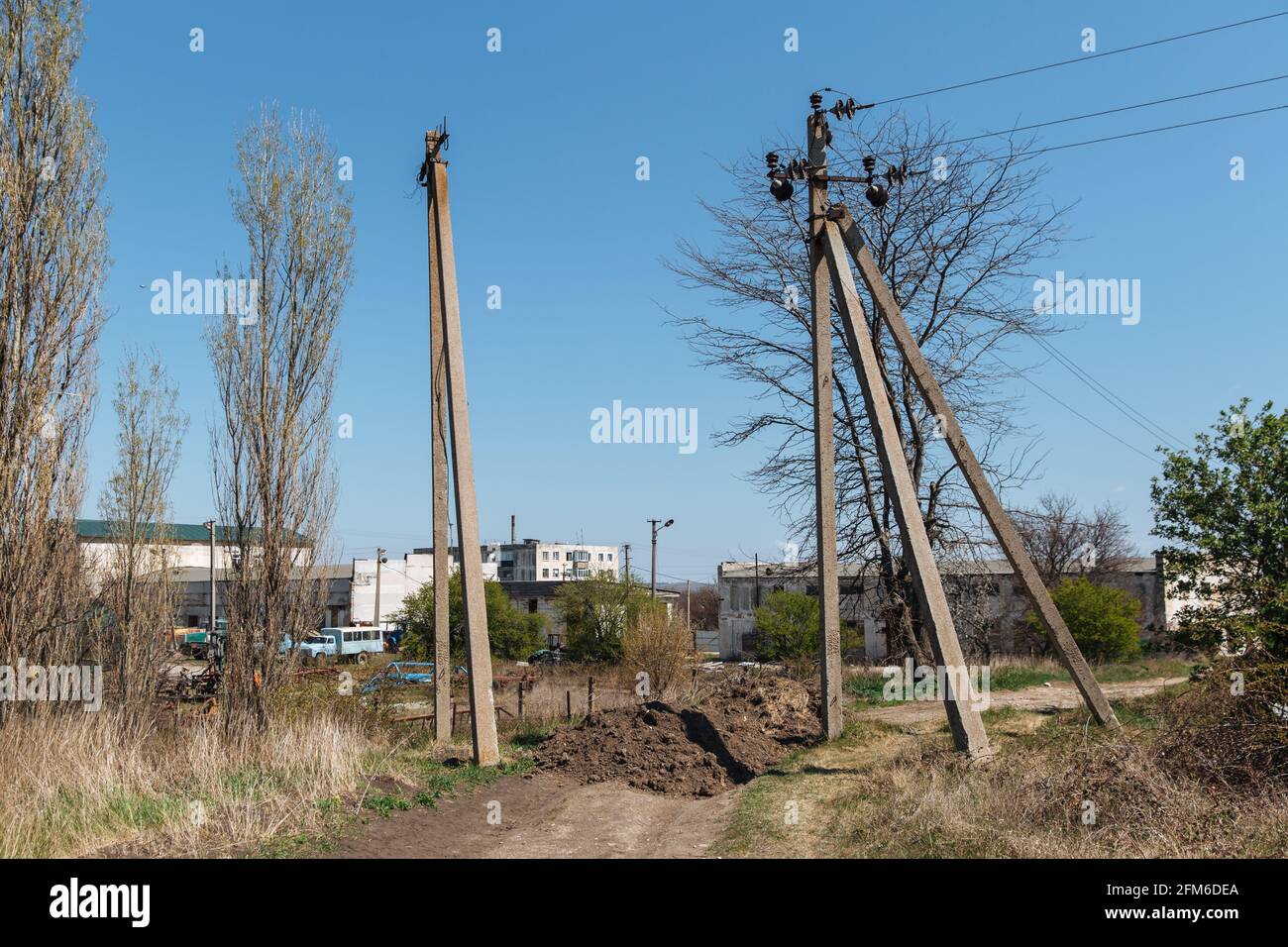 A concrete support for a power line against the background of a summer ...
