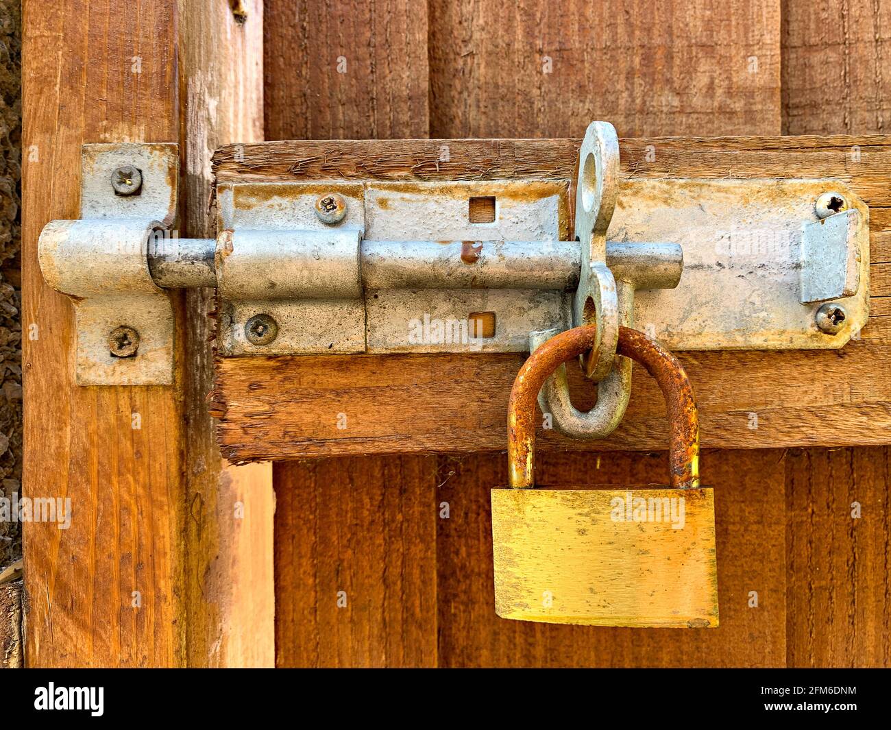Wooden garden gate with heavy galvanised bolt and brass padlock Stock ...