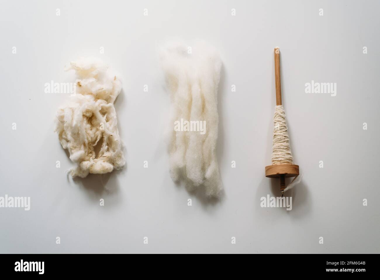 Three stages: Uncombed wool, combed wool and yarn Stock Photo - Alamy