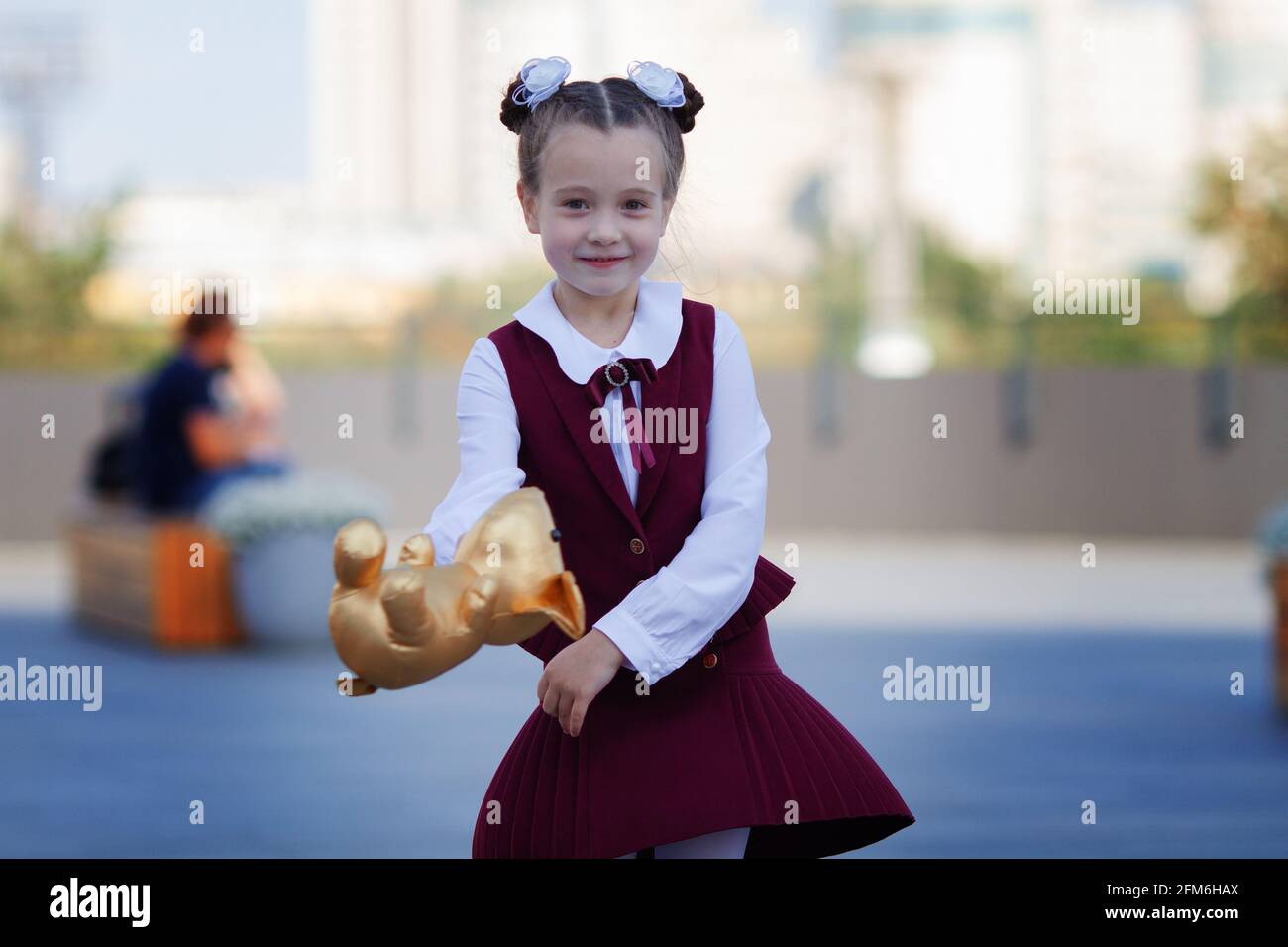 Adorable little school girl wearing stylish uniform dancing with her ...