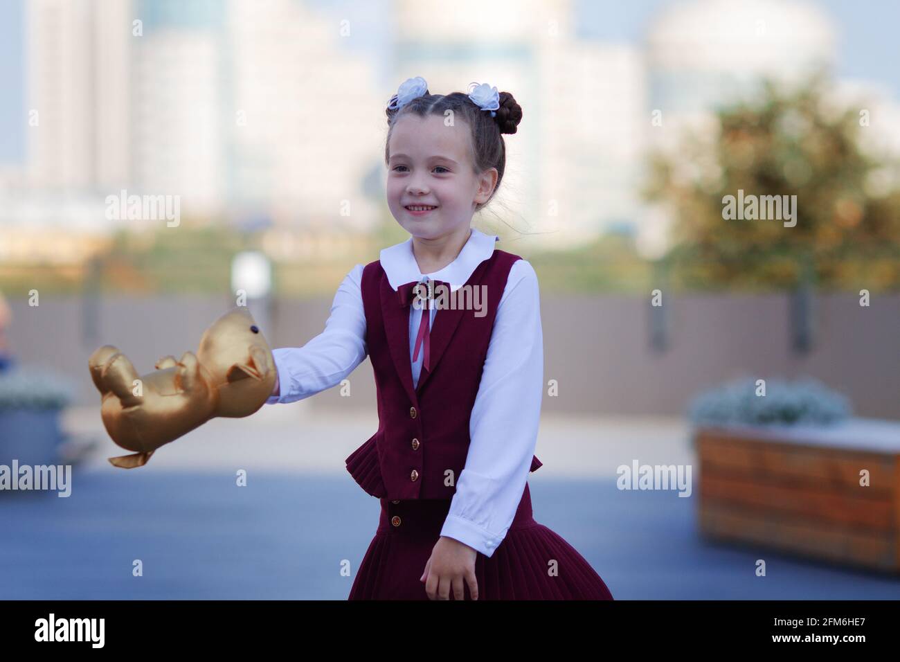 Adorable little school girl wearing stylish uniform dancing with her ...
