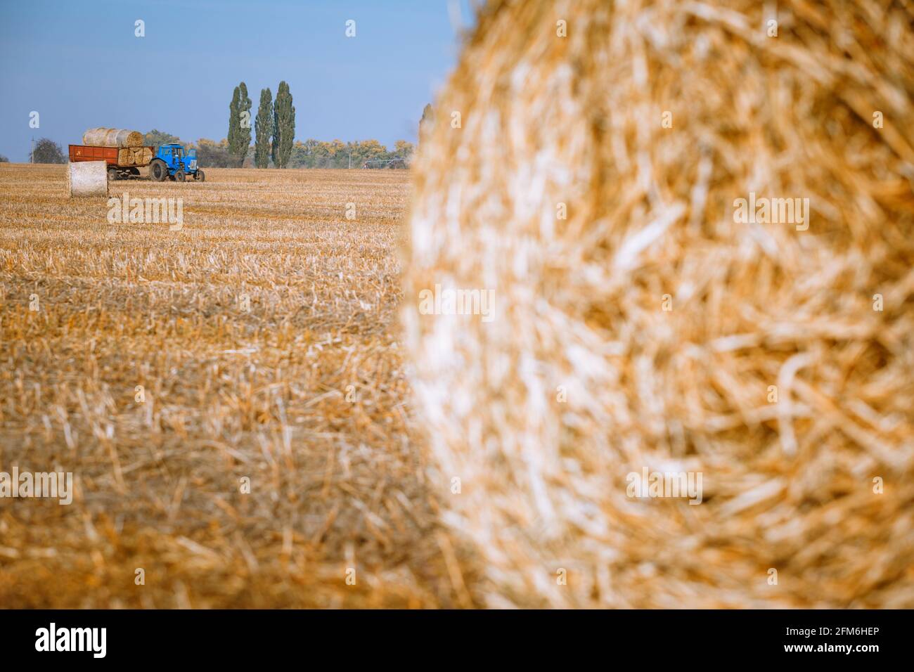 Hay bail harvesting in wonderful autumn farmers field landscape with ...