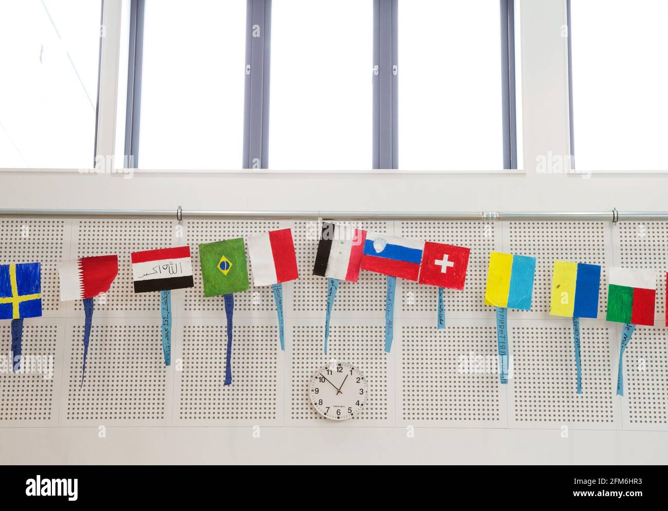 Flags, from different countries, set up inside a school Stock Photo - Alamy