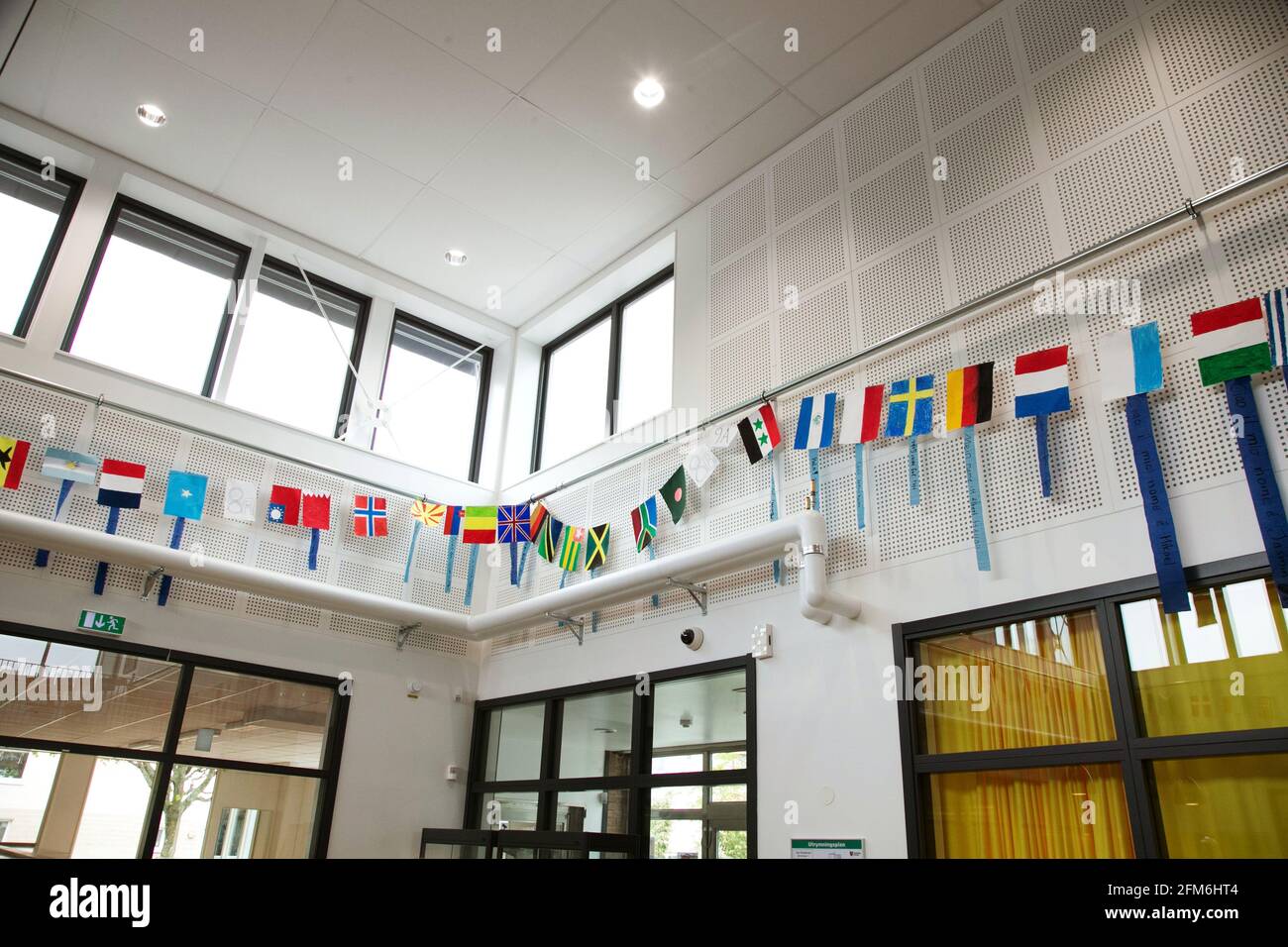 Flags, from different countries, set up inside a school Stock Photo - Alamy