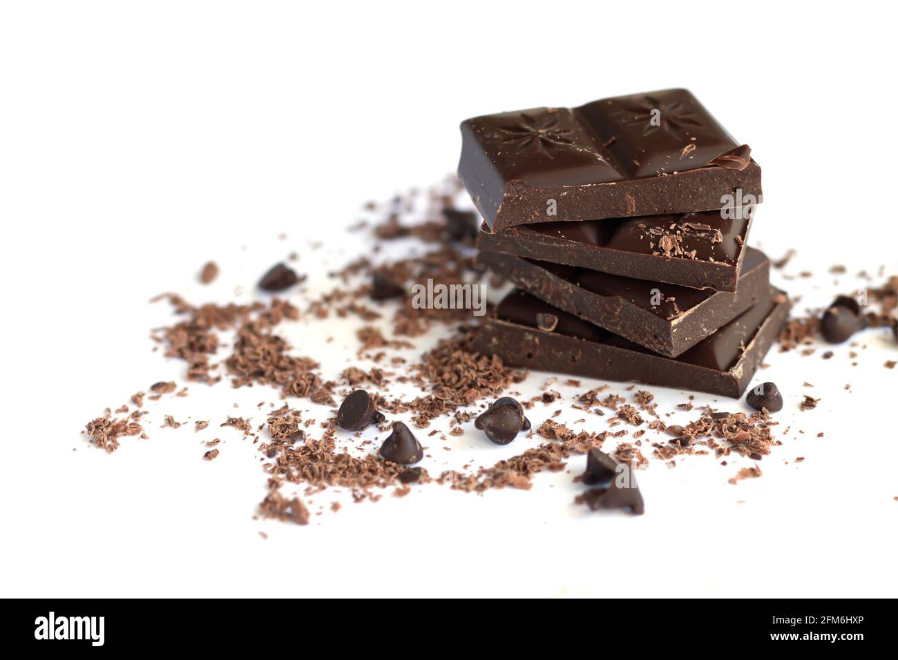 Dark chocolate stack with chocolate flakes, powder and drops isolated ...