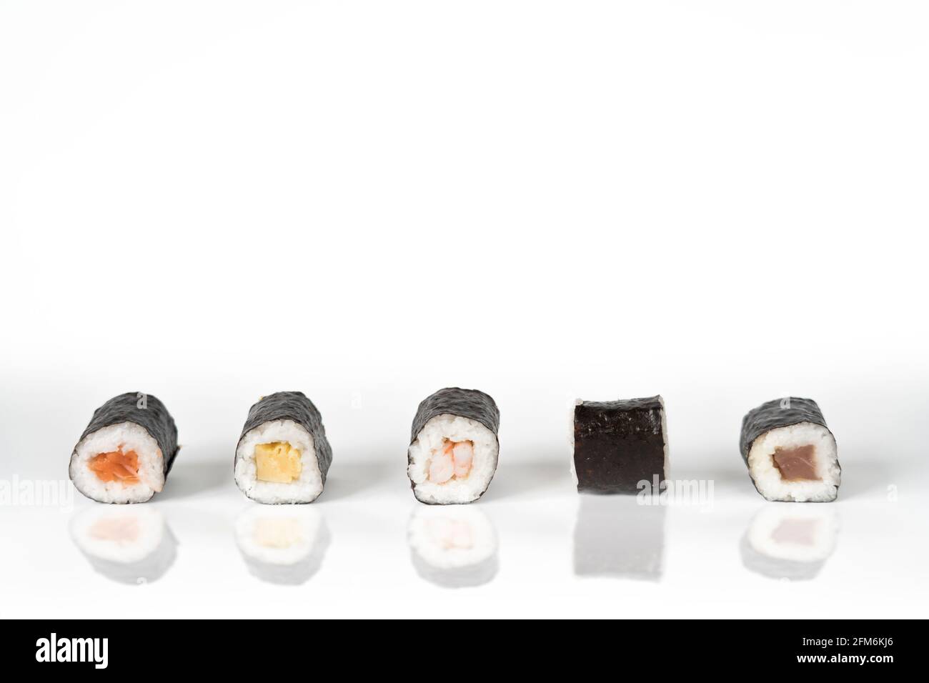 Five maki rolls in a row isolated on white background. Fresh hosomaki ...