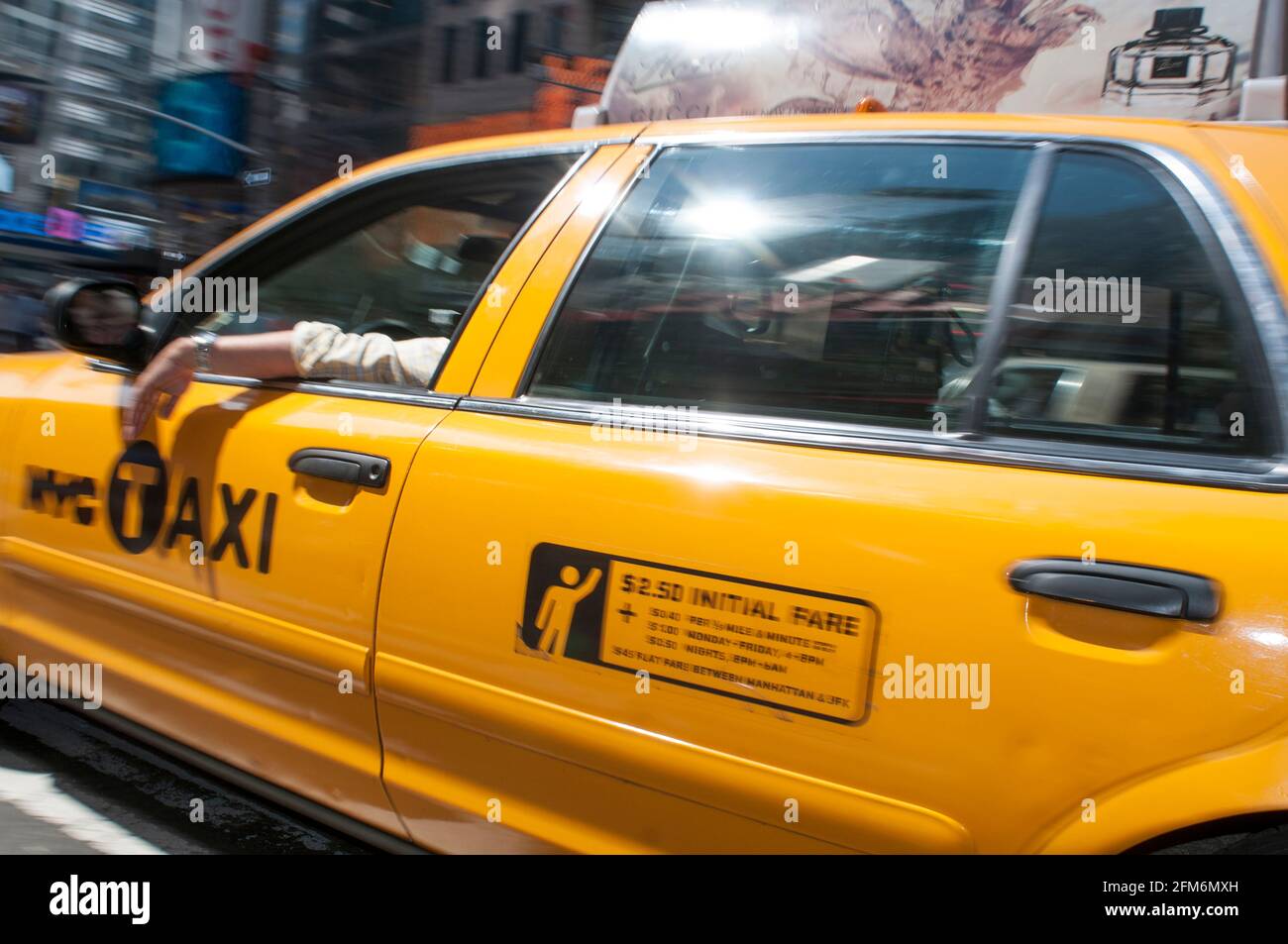 A NYC taxi known as a yellow cab drives through Times Square. The ...