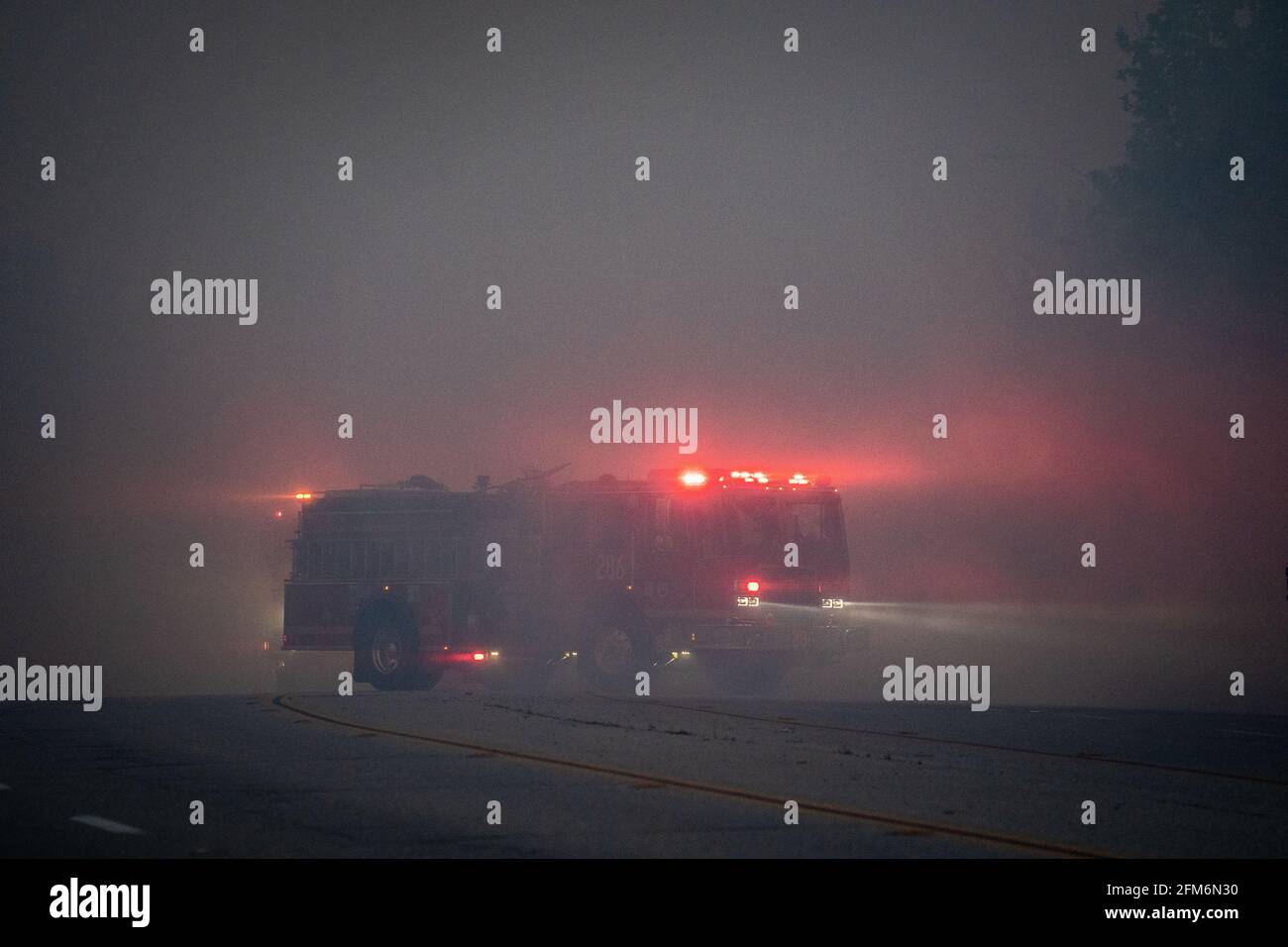 Fire truck in smoke Stock Photo - Alamy