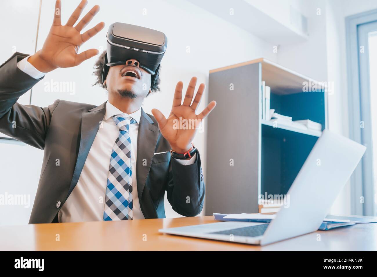Businessman using virtual reality headset Stock Photo - Alamy
