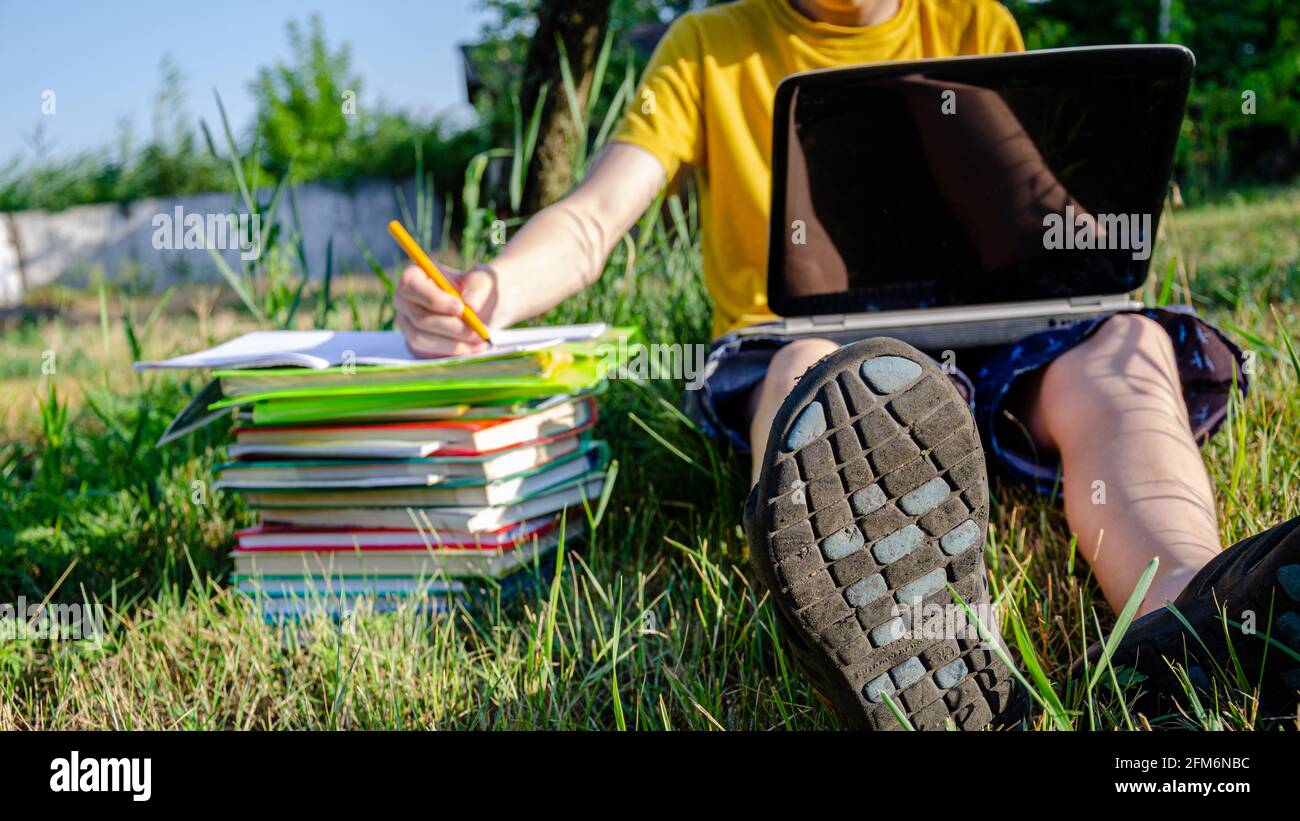 The guy is a student, a schoolboy is engaged, does homework with a ...