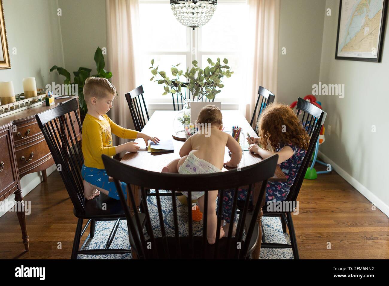 Three children remote learning at home during the covid-19 pandemic ...