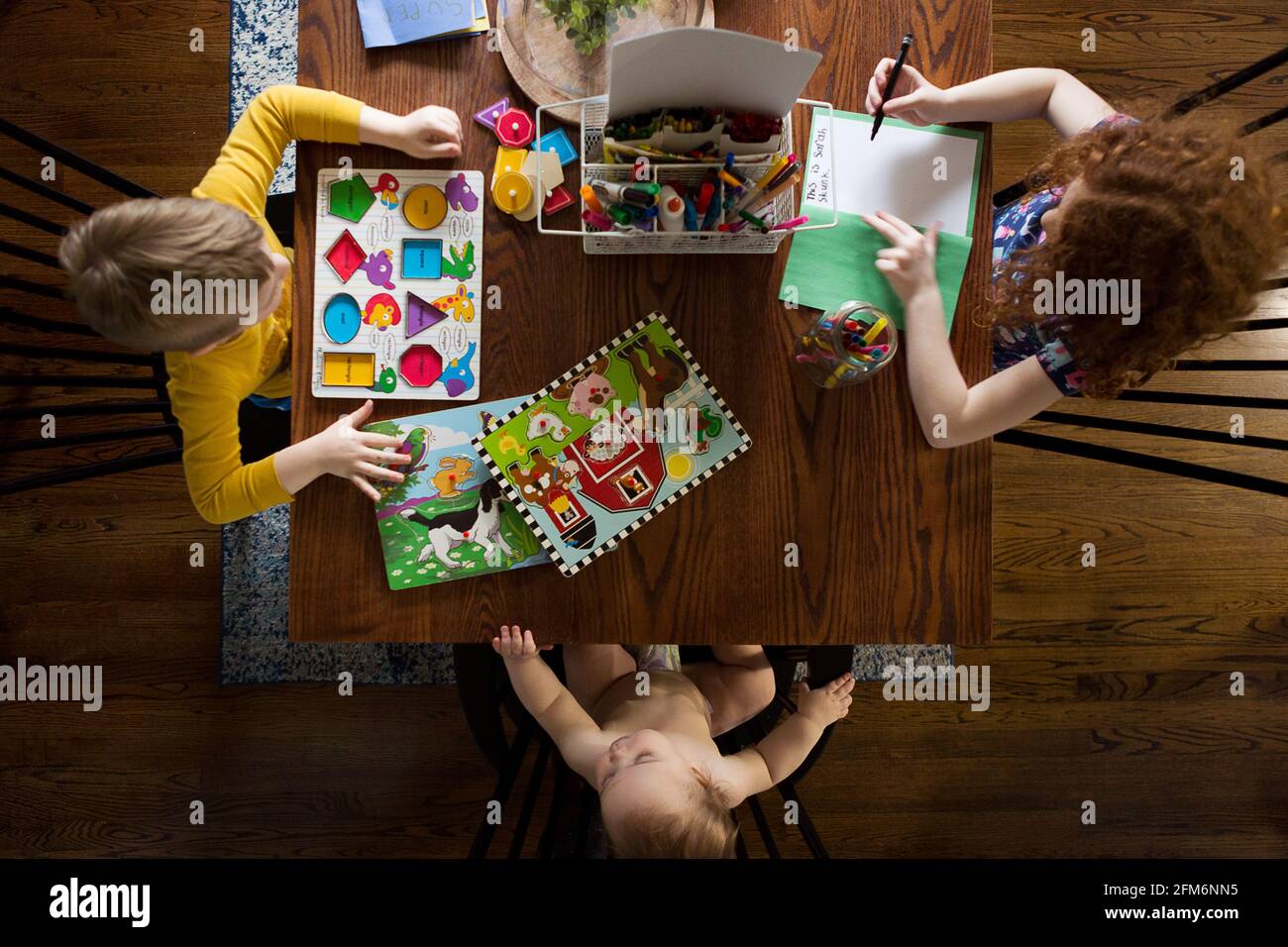 Three children remote learning at home during the covid-19 pandemic ...
