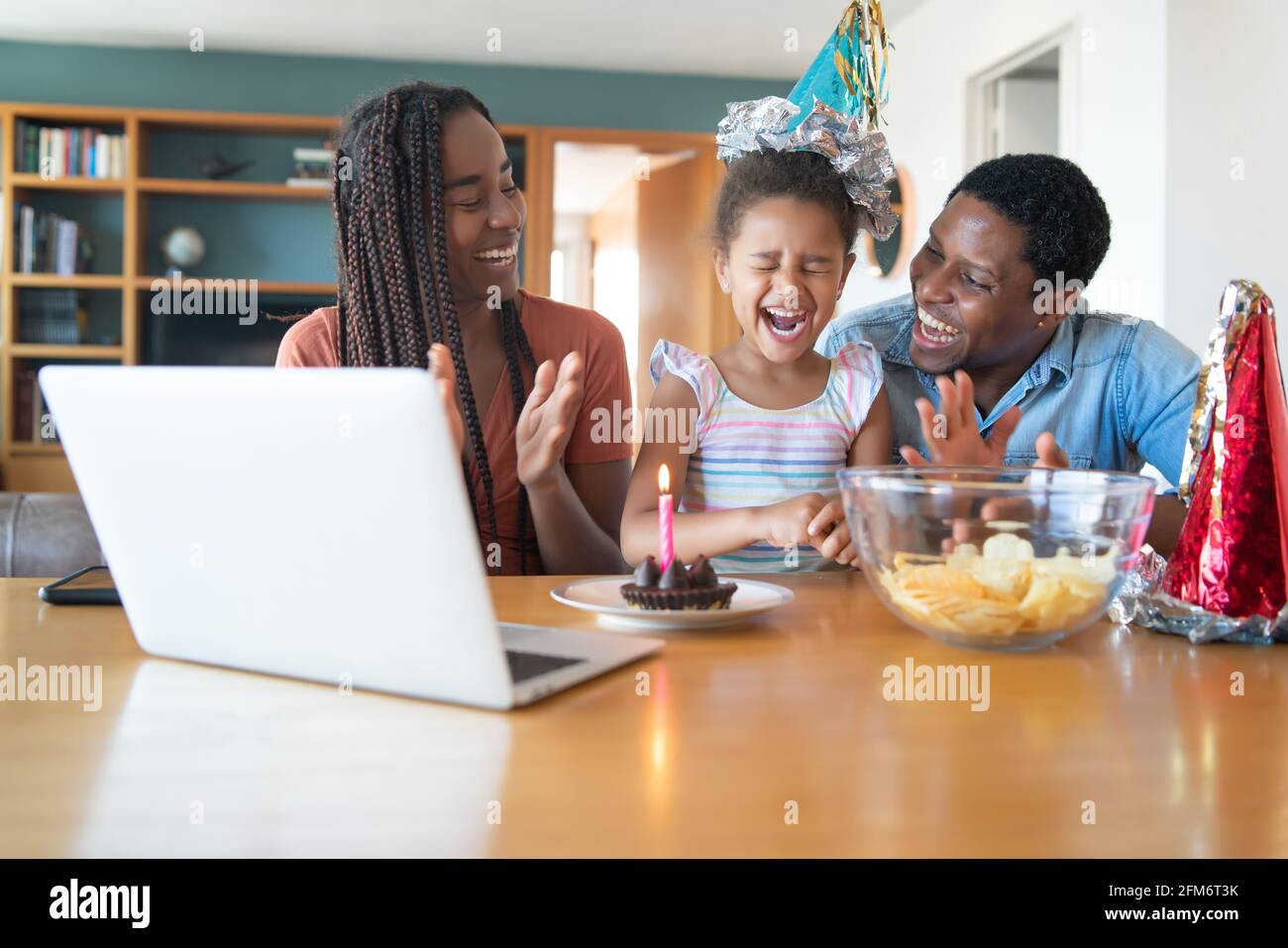 Family celebrating birthday on a video call Stock Photo - Alamy