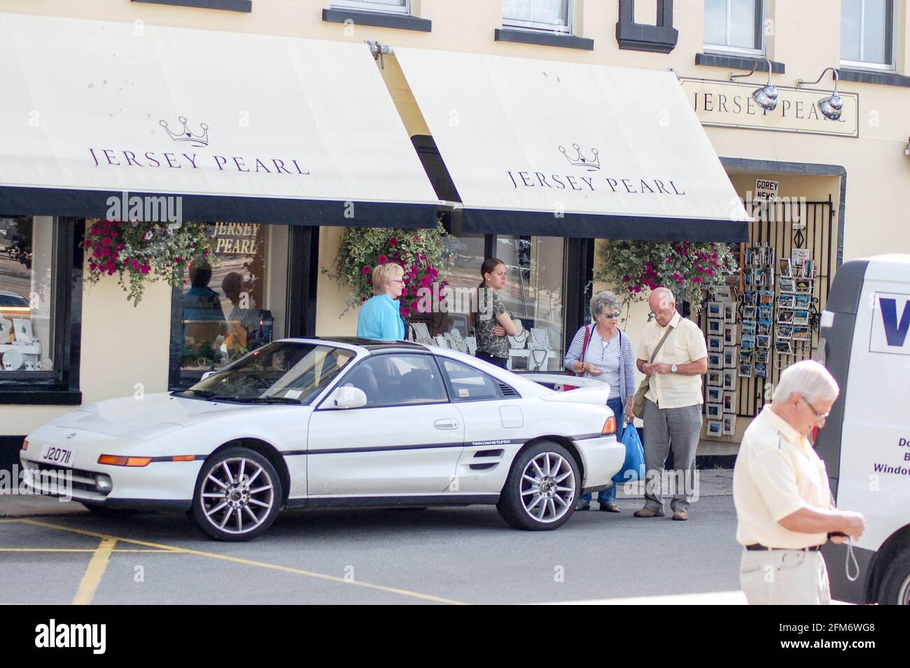 Sports car outside a pearl shop in Jersey Channel islands people ...