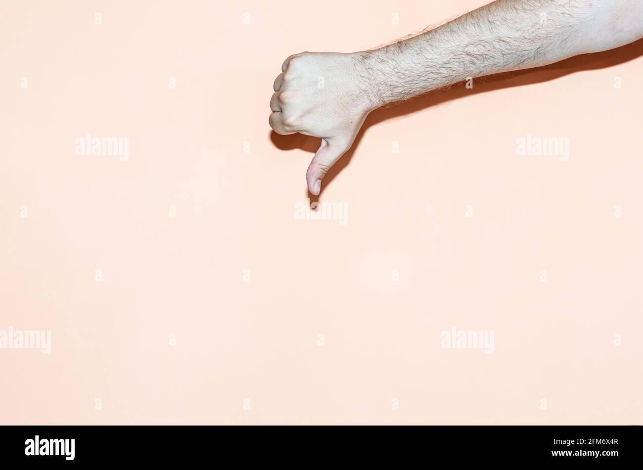 Hand gesture on orange background. Bad gesture Stock Photo - Alamy