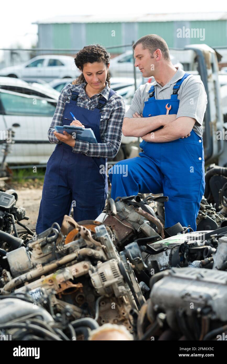 two mechanics working in car repair service Stock Photo - Alamy