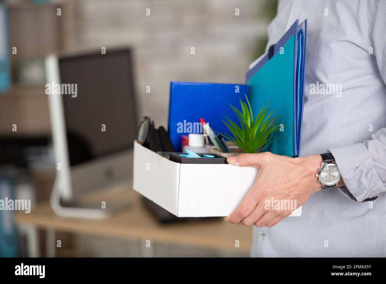 close up man carrying personal box in the office Stock Photo - Alamy