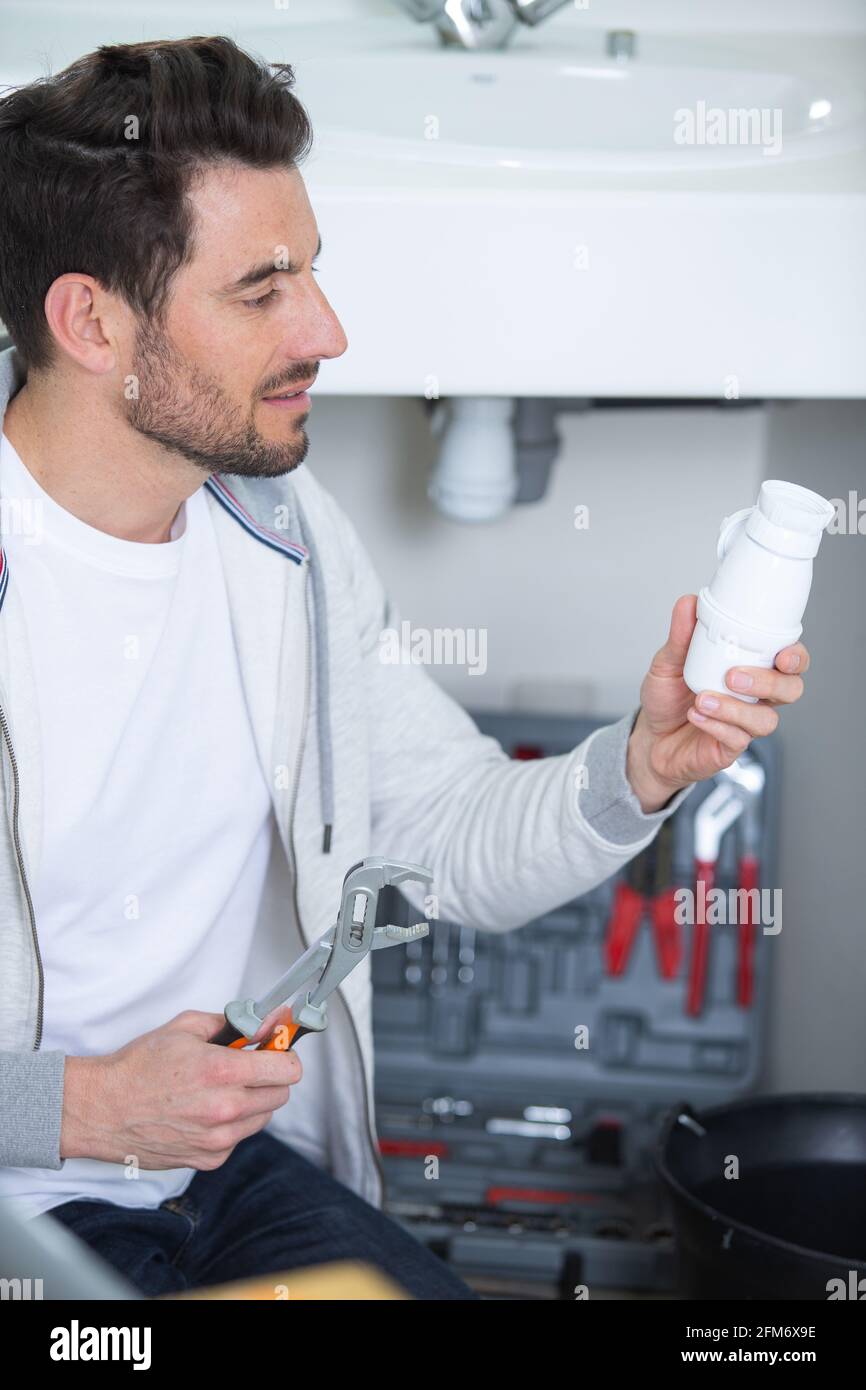 plumber at work in a bathroom Stock Photo - Alamy
