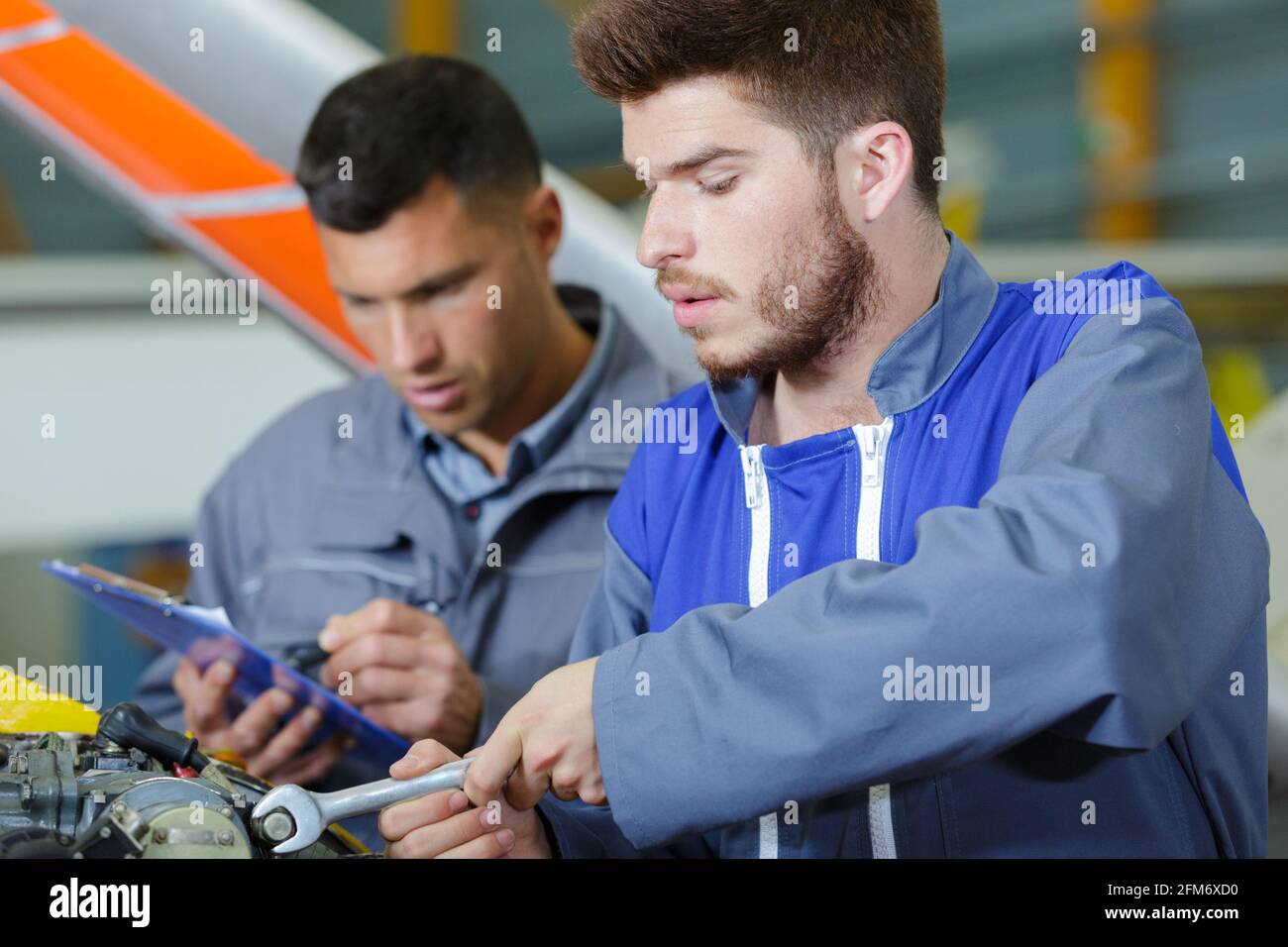 apprentice aviation mechanic using spanner on engine Stock Photo - Alamy