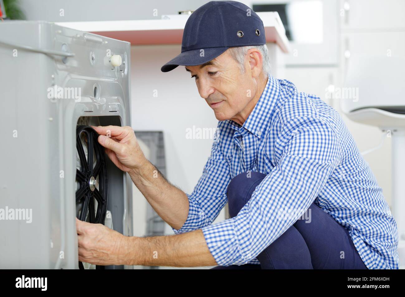 Man fixing washing machine hi-res stock photography and images - Alamy